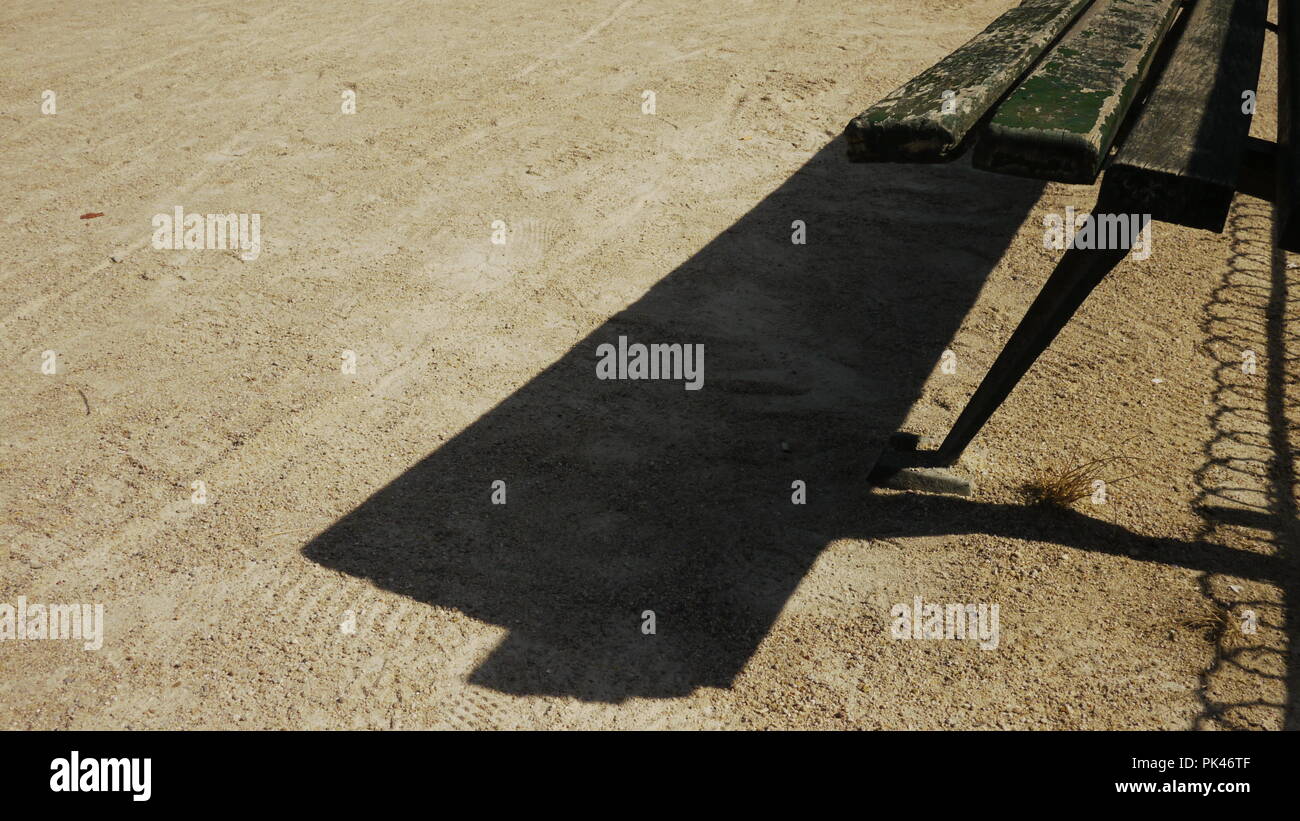 A park bench in Paris with a shadow Stock Photo - Alamy