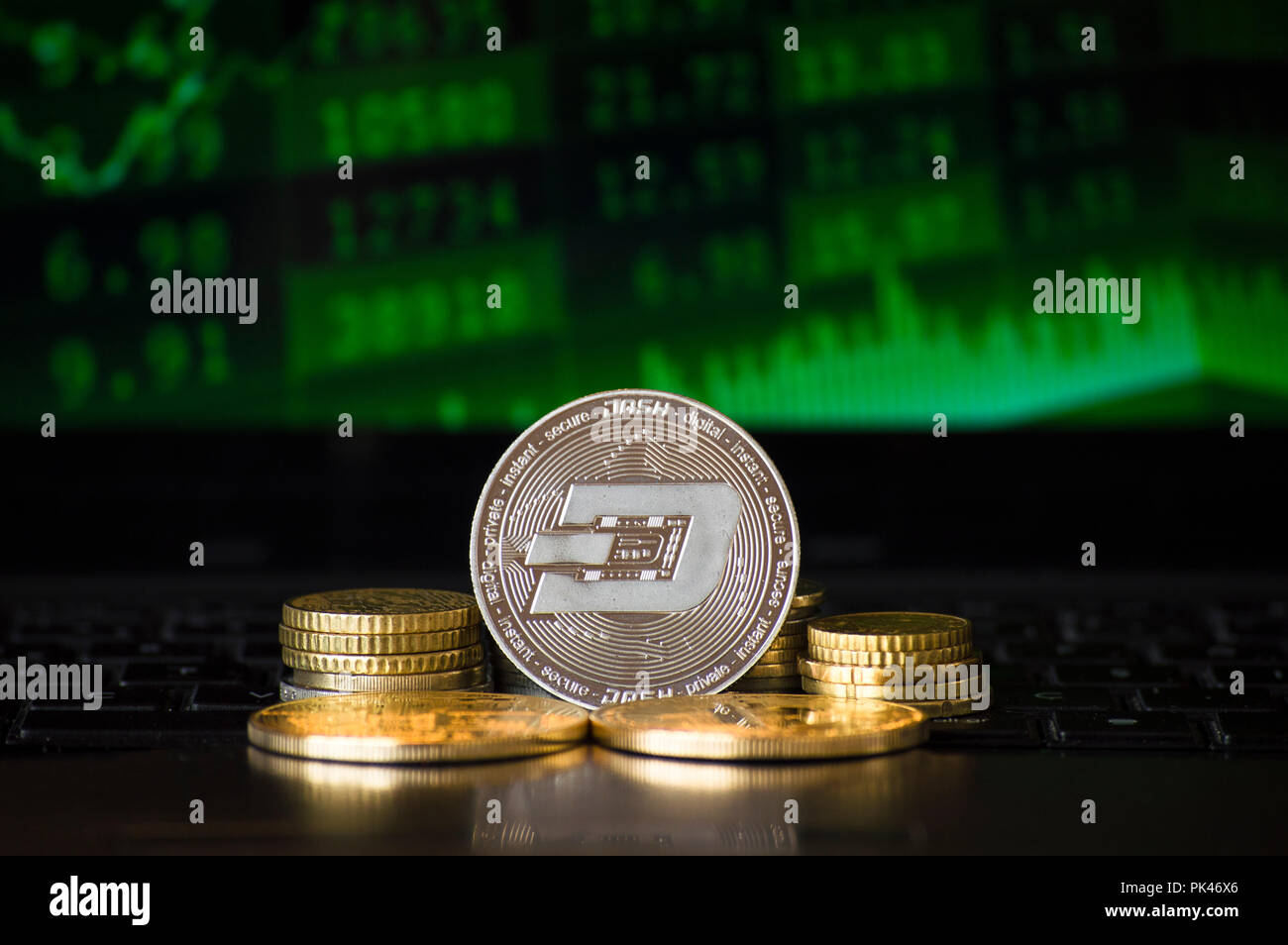 Silver Dash and coins on laptop keyboard Stock Photo - Alamy