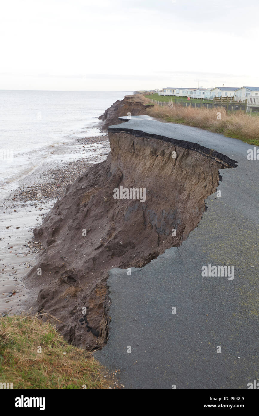End of the road. Coastal Erosion cliffs, caravans and road collapsing ...