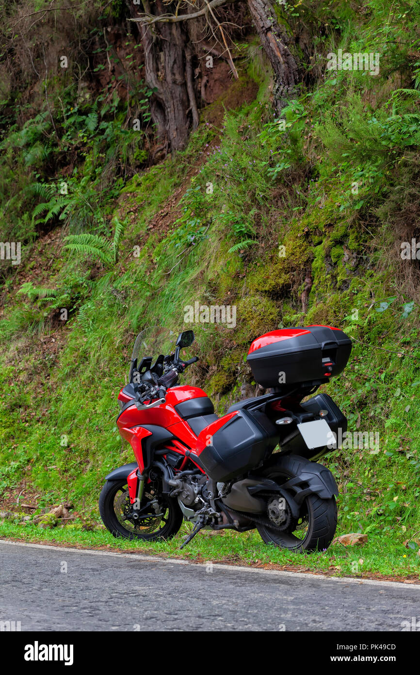 A large red motorcycle parked on the side of the road Stock Photo - Alamy