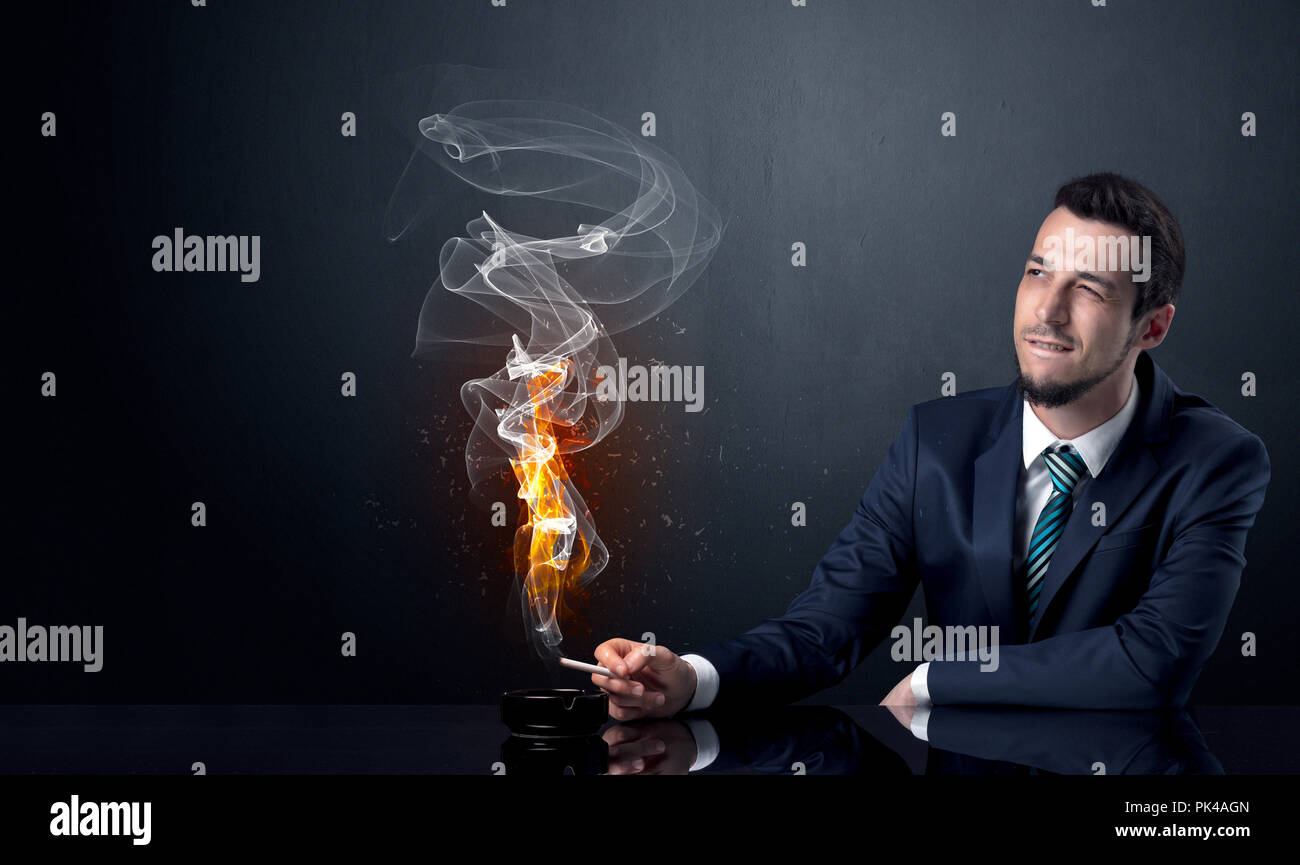 Businessman smoking with inferno effect Stock Photo - Alamy