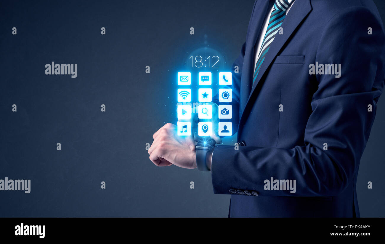 Businessman wearing smartwatch with application icons Stock Photo - Alamy