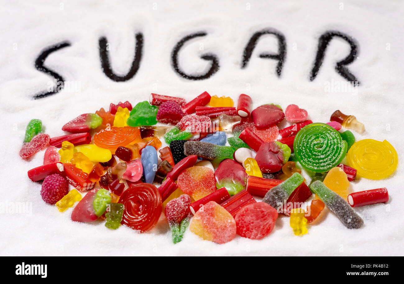 Mix of tempting sweets and candies with sugar spread and written text ...