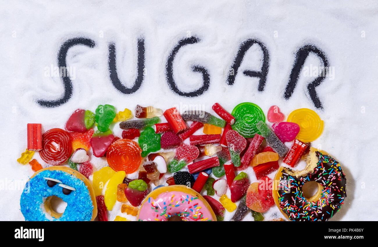 Mix of tempting sweet cakes, donuts and candy with sugar spread and ...