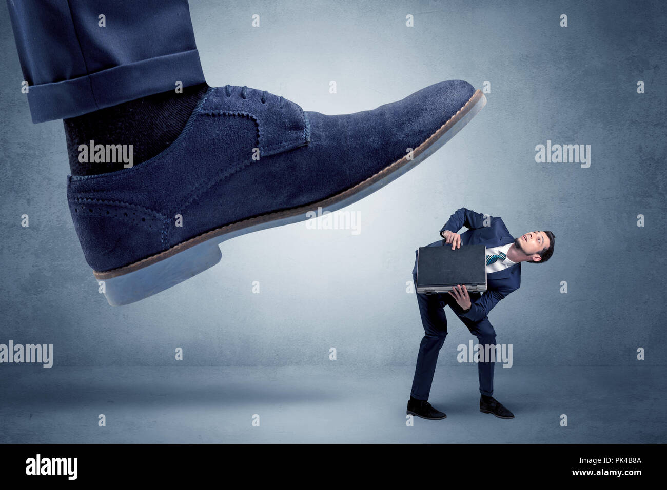 Big foot trying to crush small man who is afraid of that Stock Photo ...