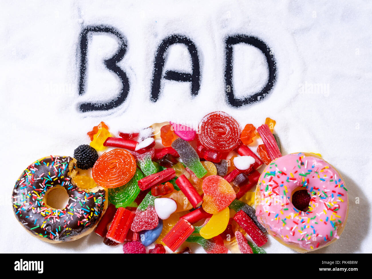 Mix of tempting sweet cakes, donuts and candy with sugar spread and ...