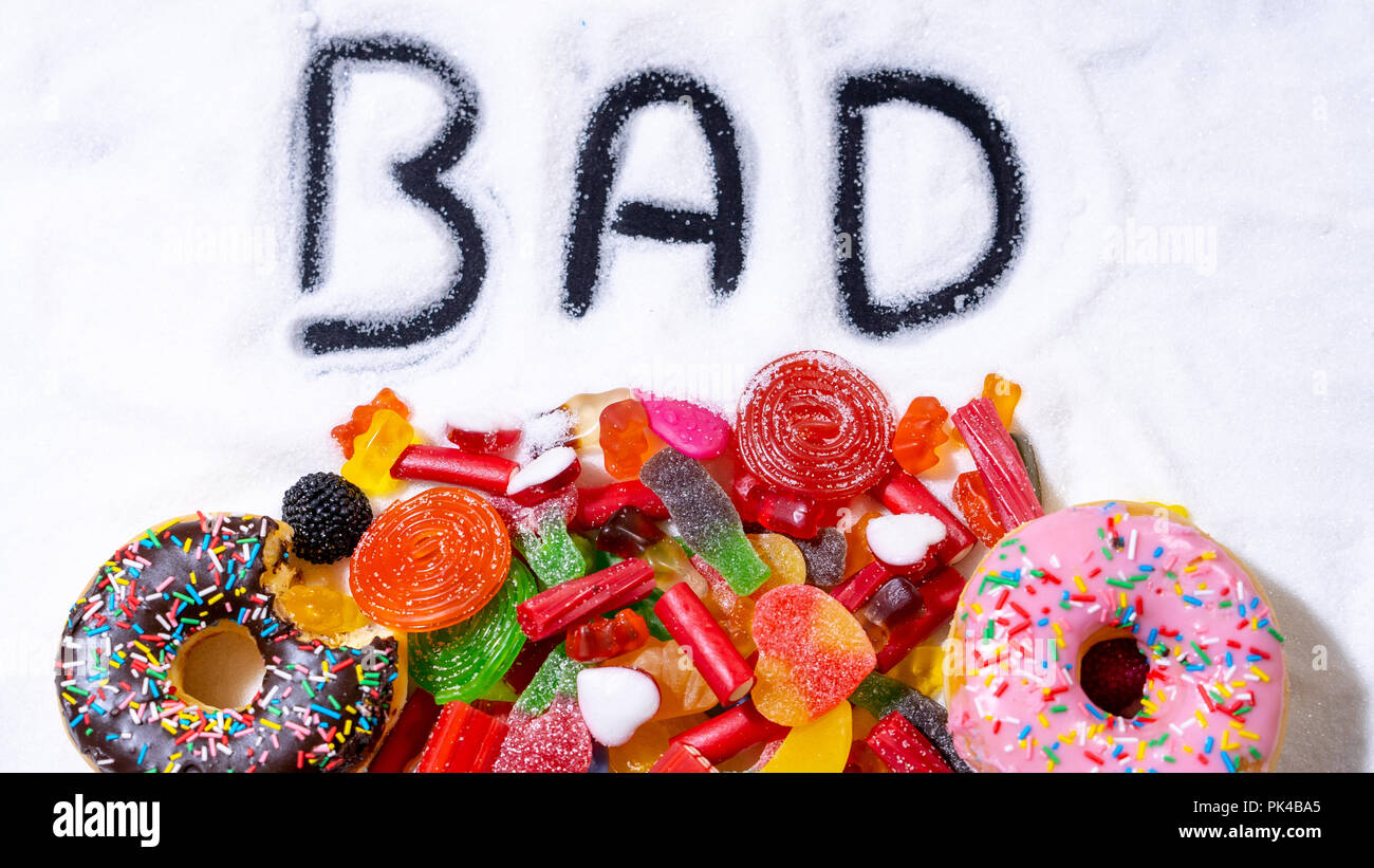 Mix of tempting sweet cakes, donuts and candy with sugar spread and ...