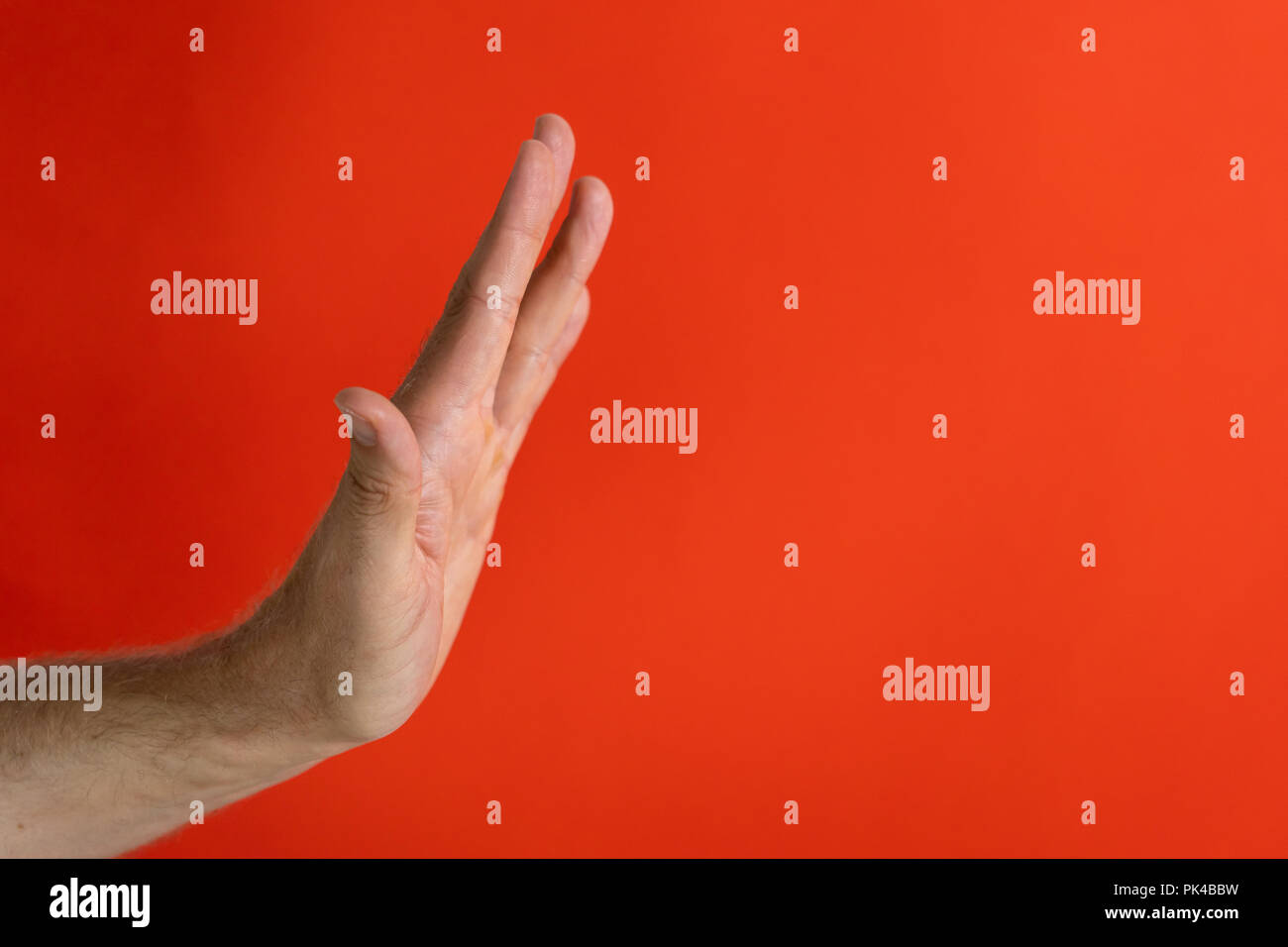 Studio photo of a strong man hand showing stop gesture and sign ...