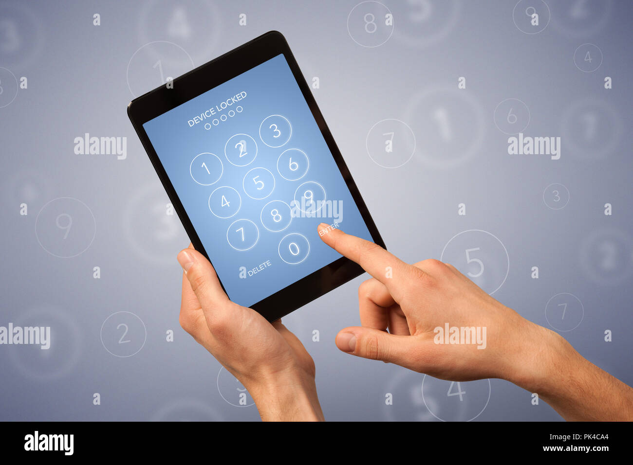 Female fingers touching tablet with locked device requiring passcode ...