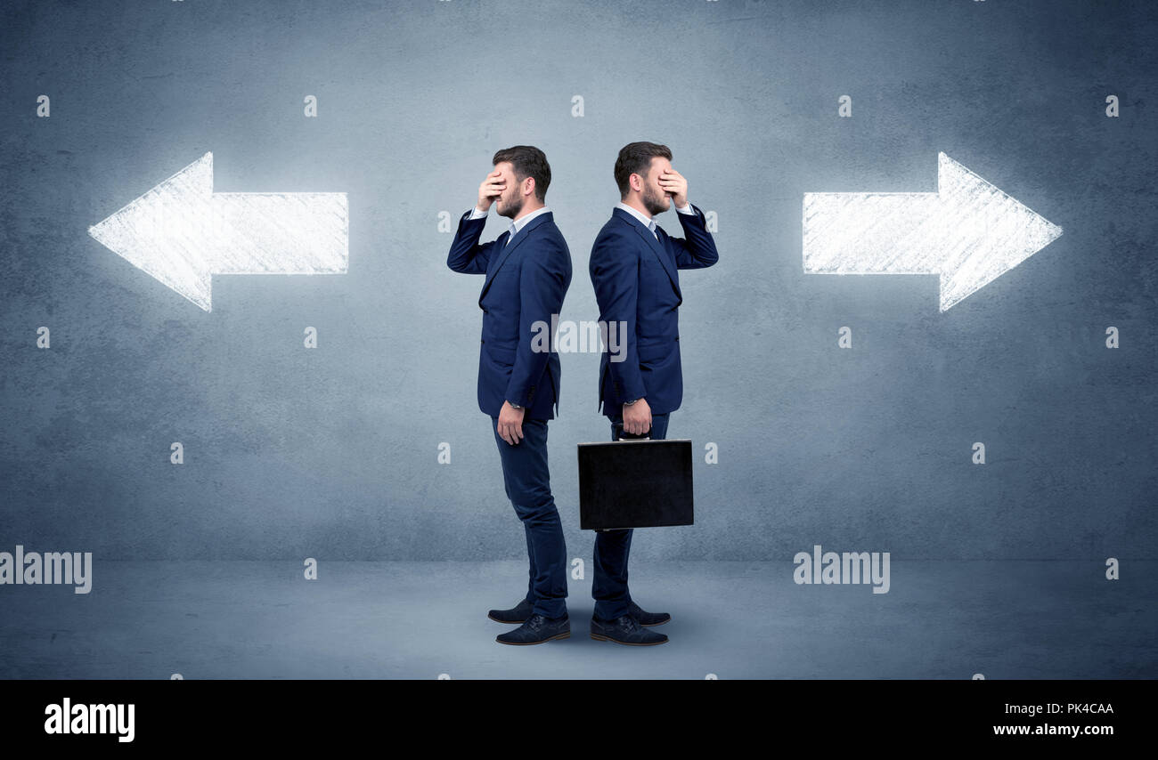 Young conflicted businessman choosing between two directions Stock ...