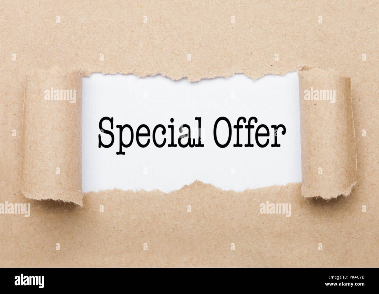 Special Offer concept text appearing behind torn brown paper envelope ...
