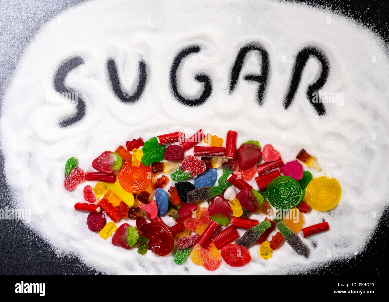 Mix of tempting sweets and candies with sugar spread and written text ...