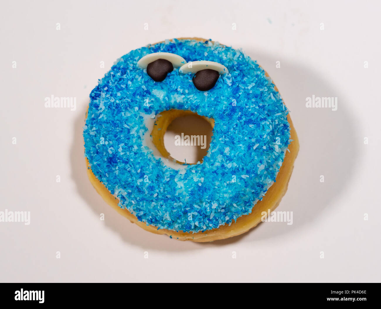 Top view studio photo of a delicious and tempting happy donut with blue ...