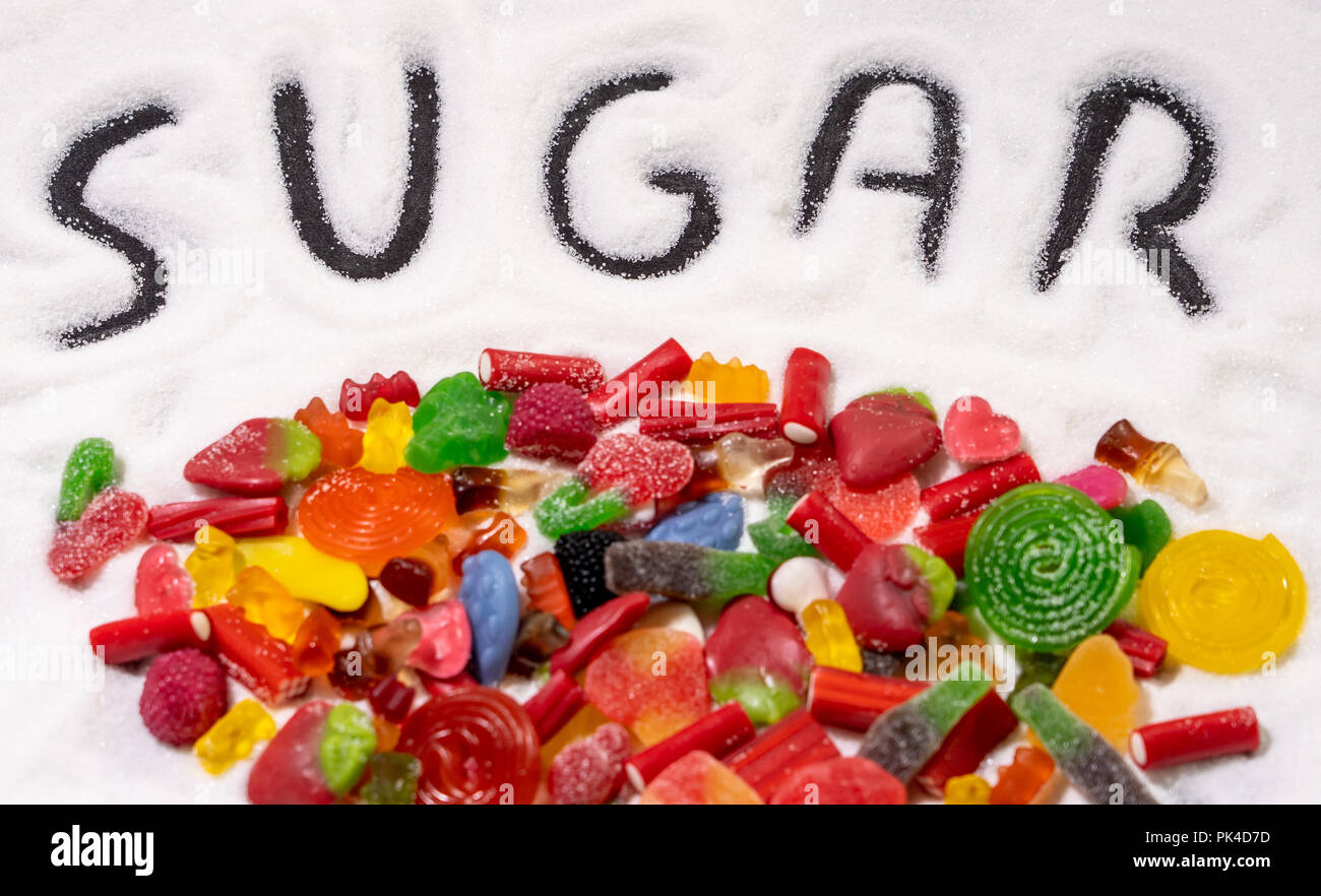 Mix of tempting sweets and candies with sugar spread and written text ...