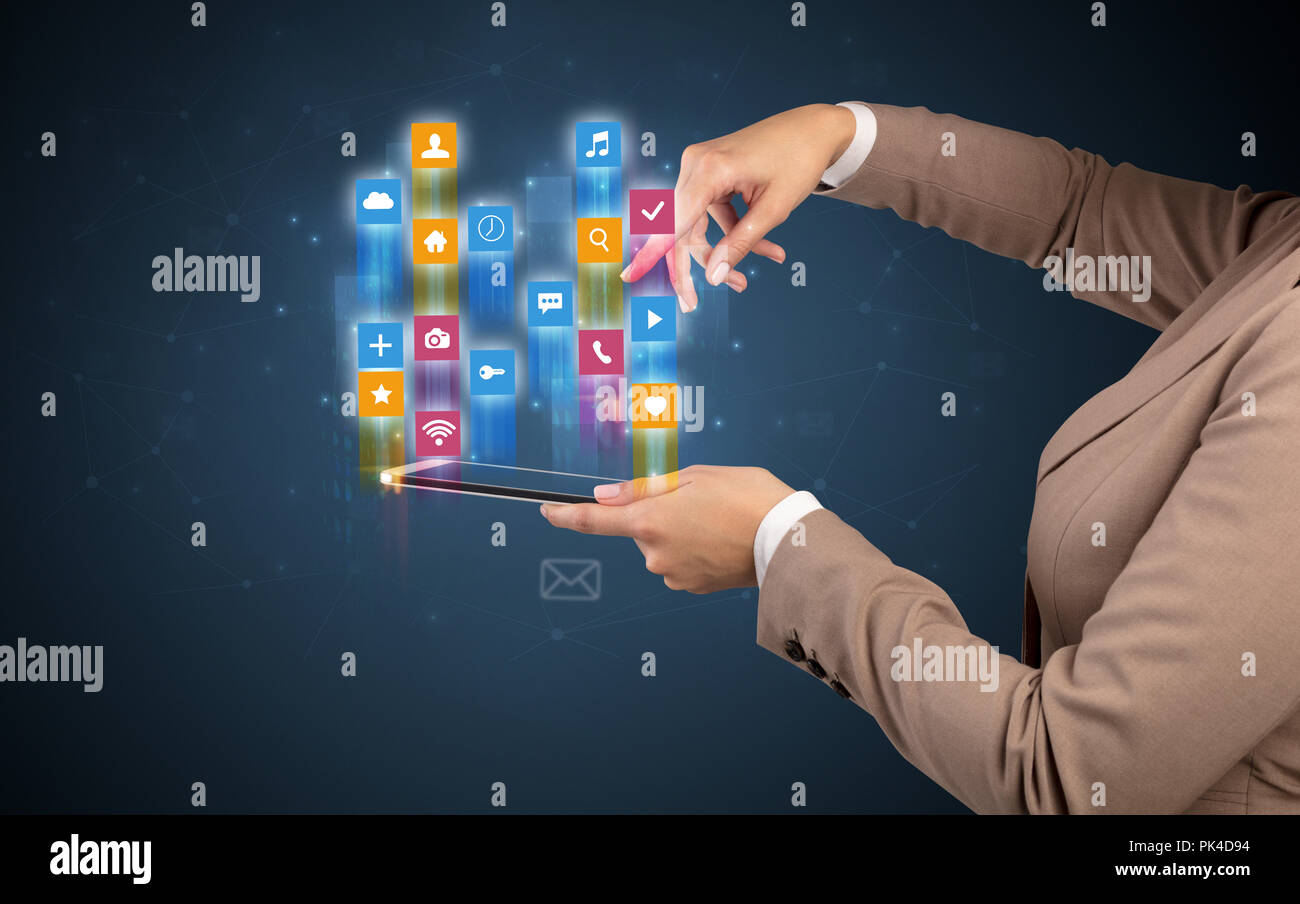 Female elegant hand holding tablet with colourful application icons ...