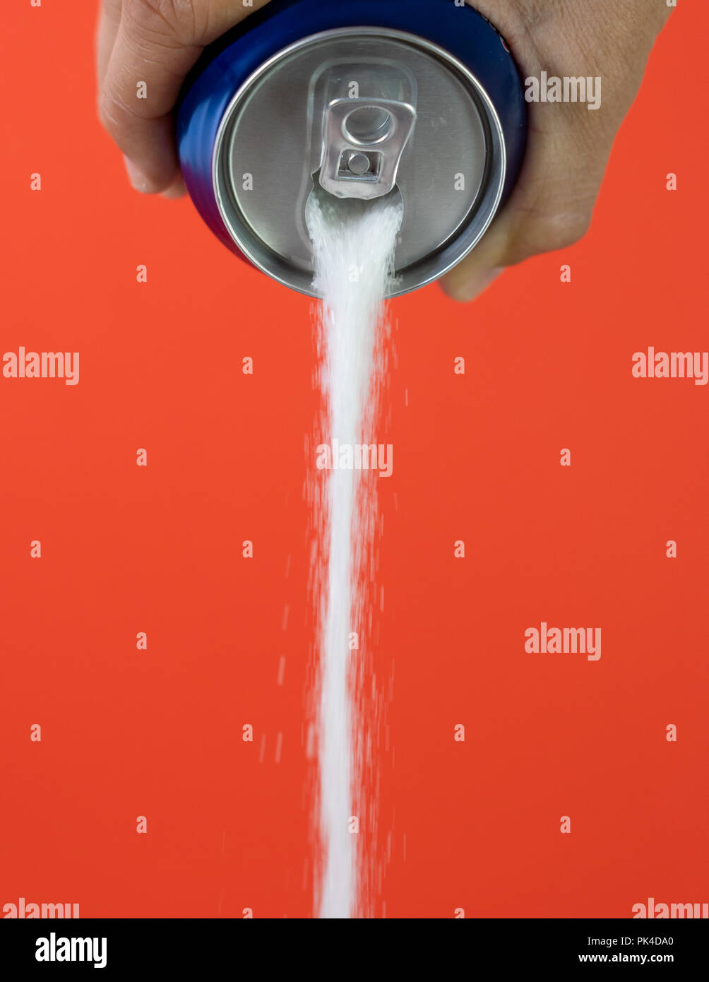 Hand holding soda can pouring lots of sugar in metaphor of sugar ...