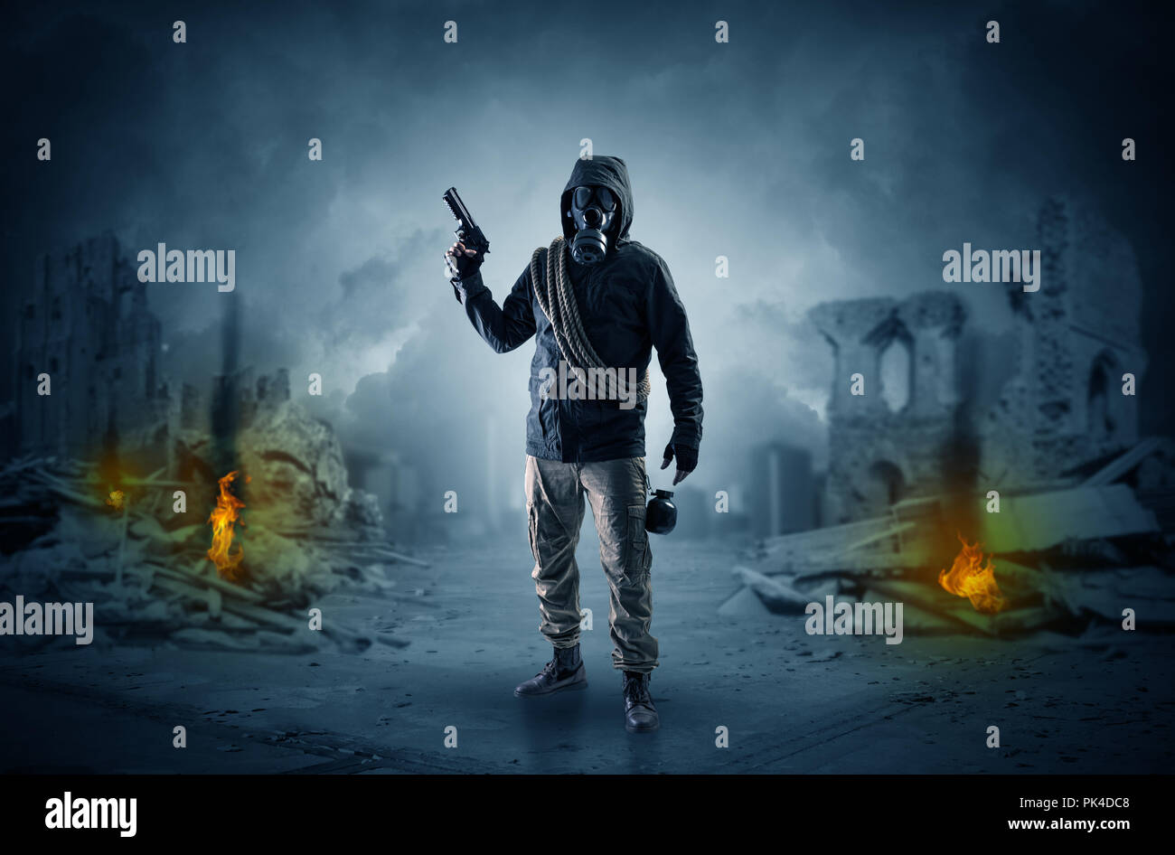 Destroyed place after a catastrophe with man in gas mask and weapon on ...