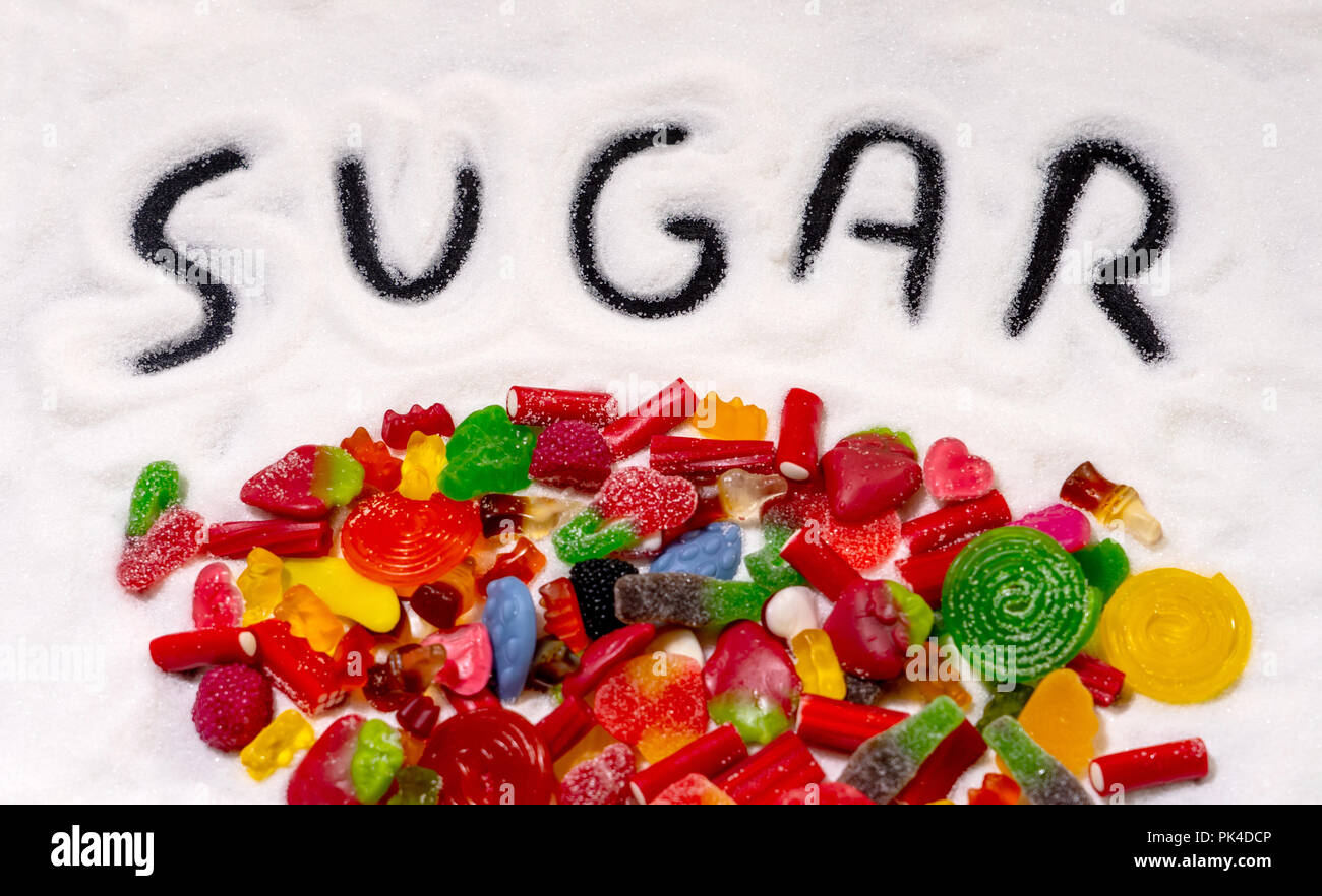 Mix of tempting sweets and candies with sugar spread and written text ...