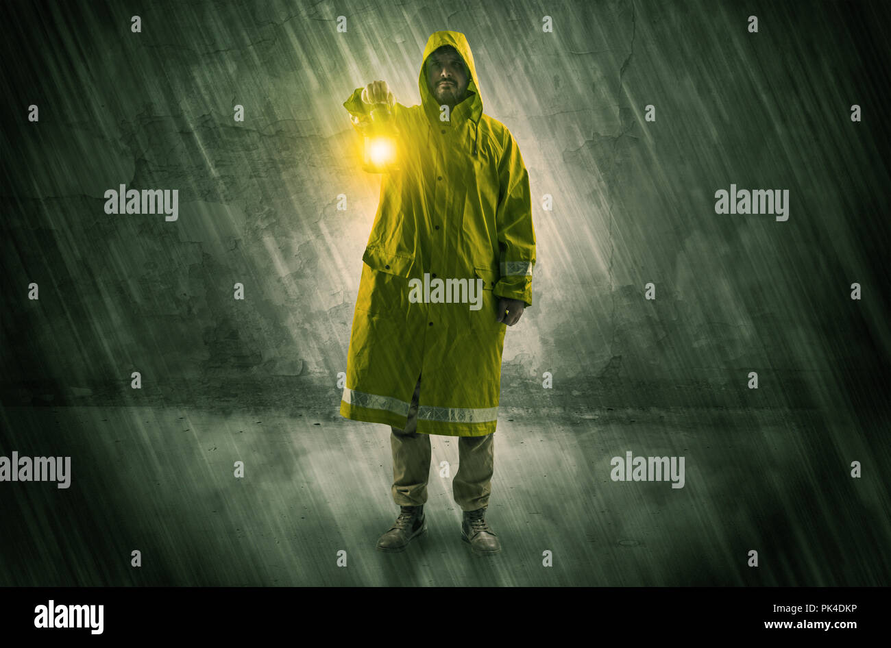 Ugly wayfarer with lantern in his hand in front of a crumbly wall ...