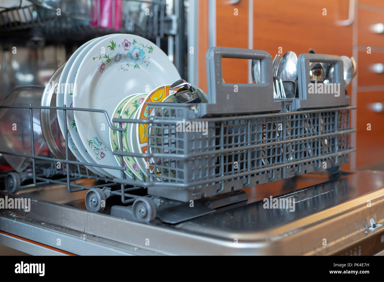 Dishwashing machine filled with dishes. Kitchen appliances helpful in ...