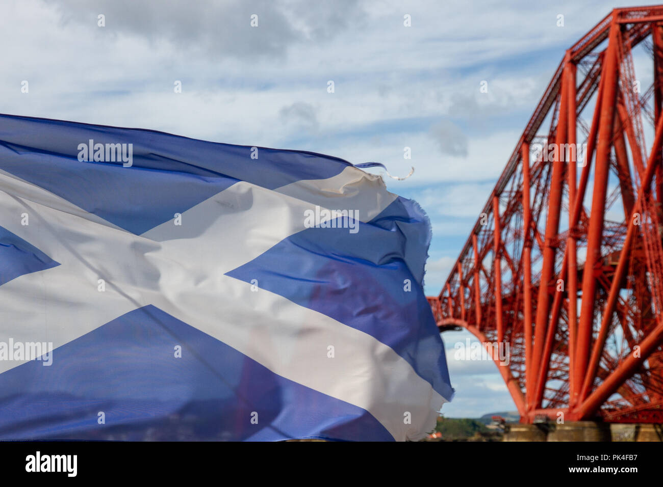Forth Rail Bridge alongside a fluttering Scottish Saltire Stock Photo ...