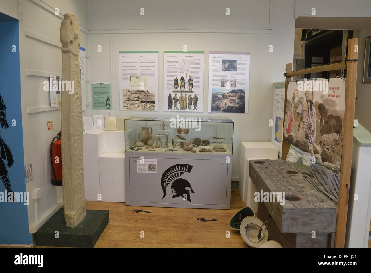 Roman artefacts and a celtic cross at Tenby Museum, Tenby, Wales, UK ...