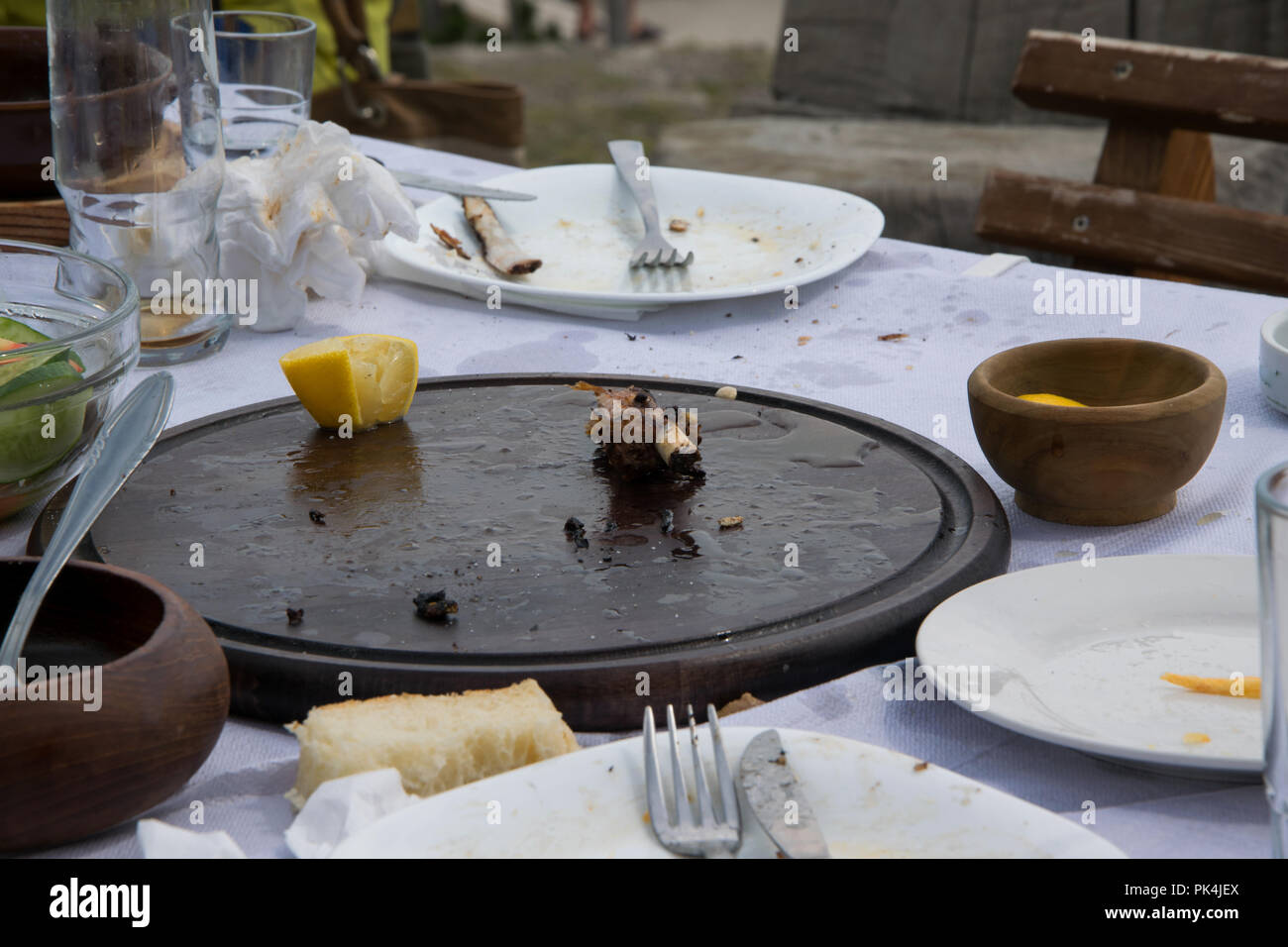 Messy table with empty dirty dishes after eating Stock Photo - Alamy