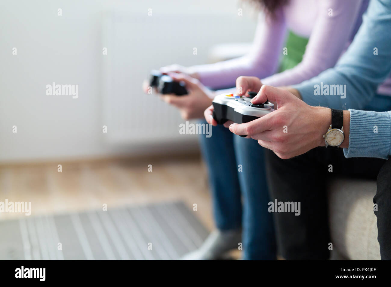 Young couple having fun playing video games Stock Photo - Alamy