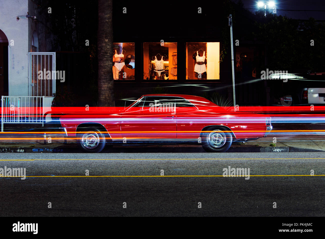 A view of a vintage classic American muscle sports car and light trails ...