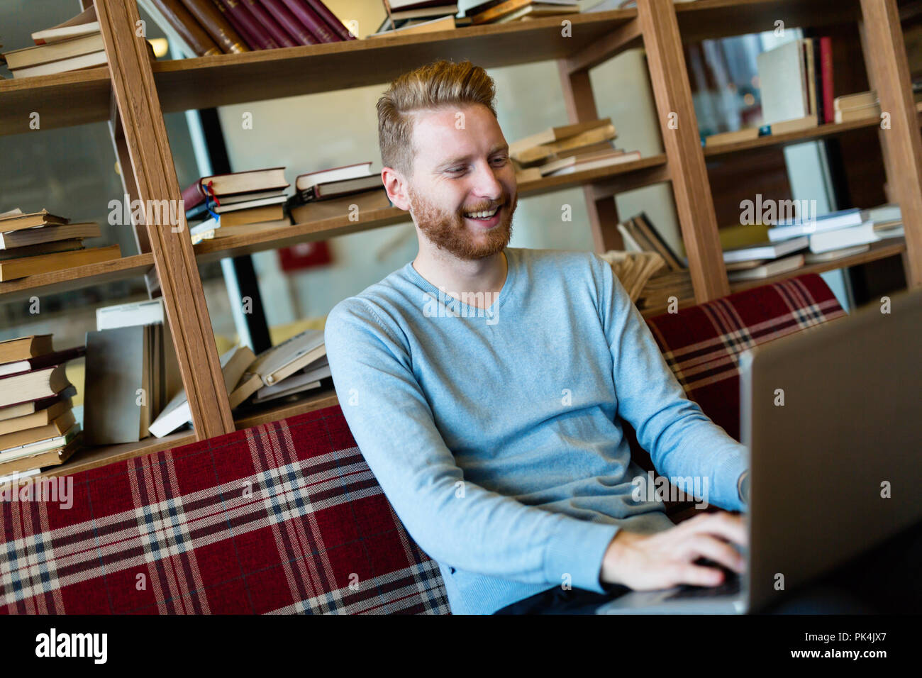 Male student holding laptop hi-res stock photography and images - Alamy