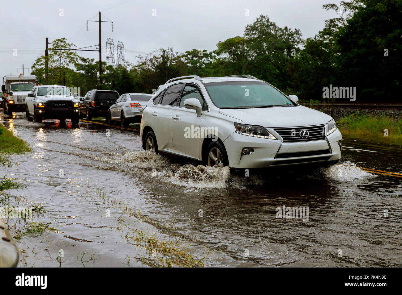 Car driving through flooded road natural disaster hi-res stock ...