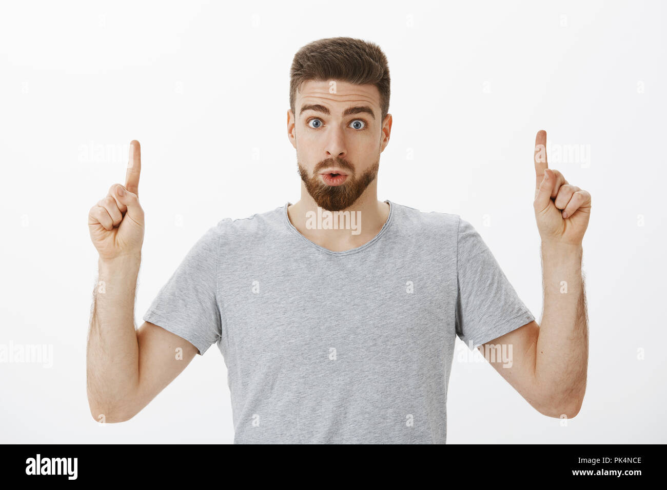 Indoor shot of interested and intrigued handsome masculine man with ...