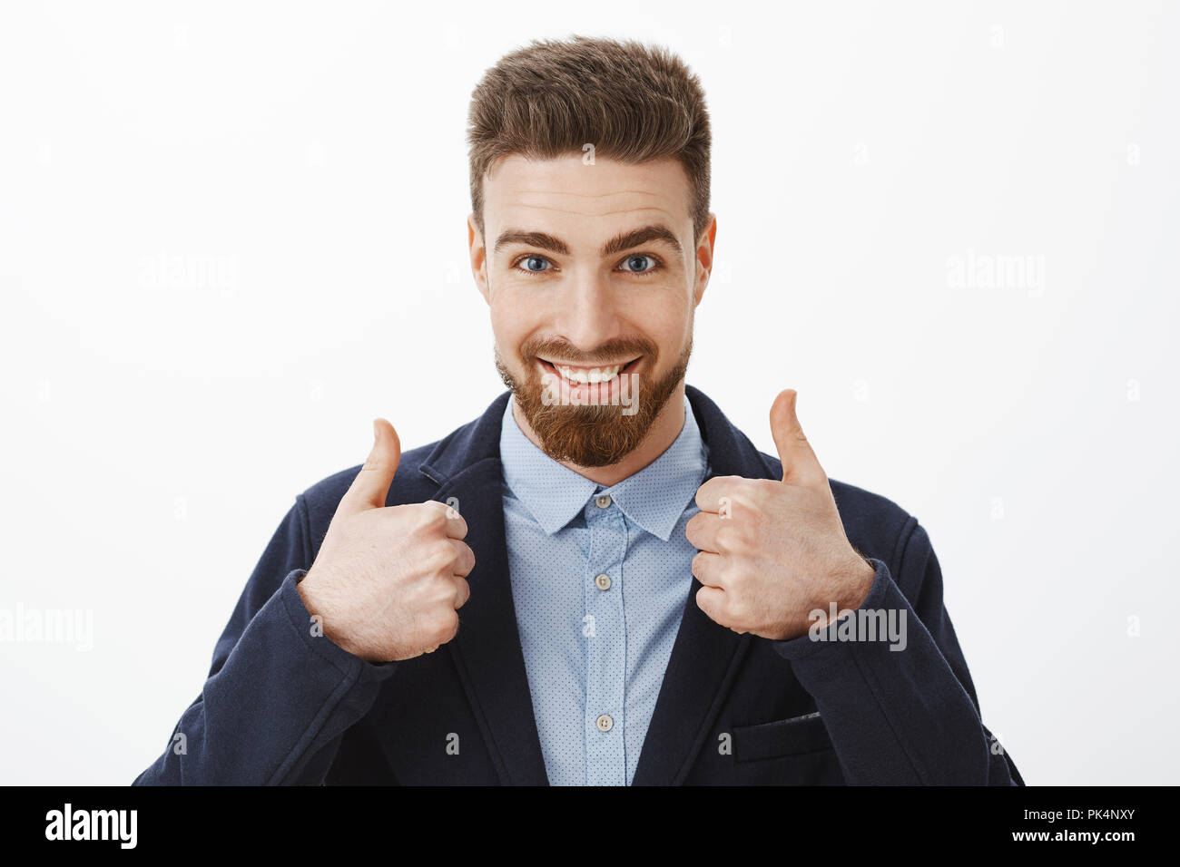 Energized good-looking and assured successful man with beard and blue ...