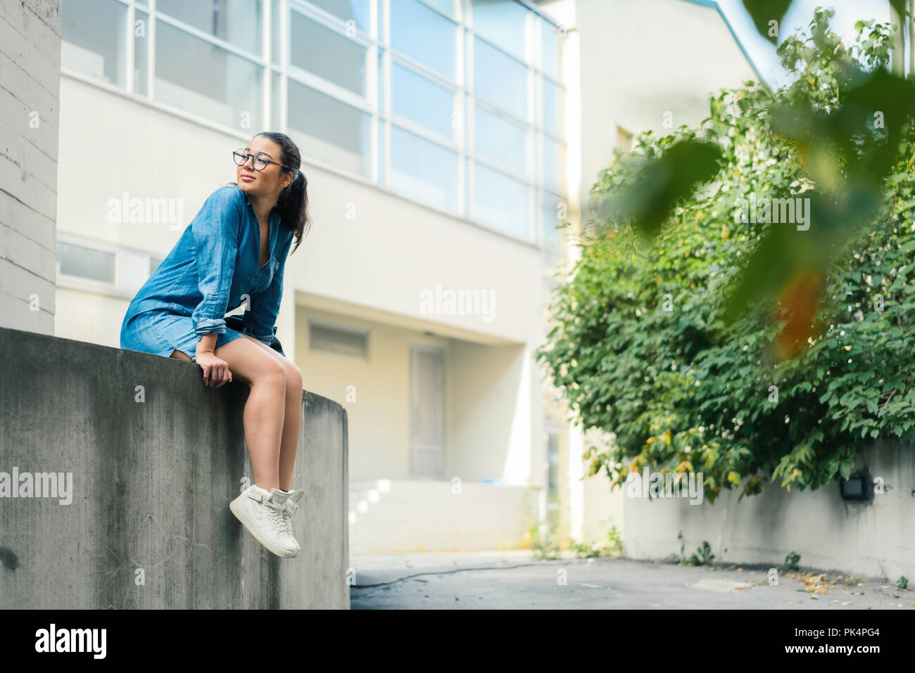 Distant plan of young attractive bespectacled woman looking aside Stock ...