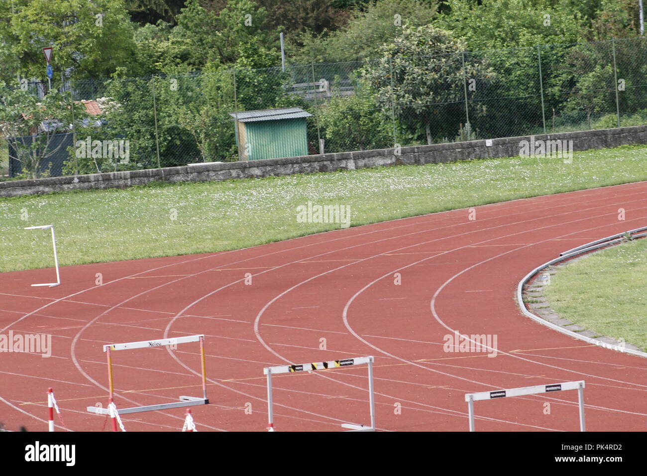 Athlete track or running track among green meadows Stock Photo - Alamy