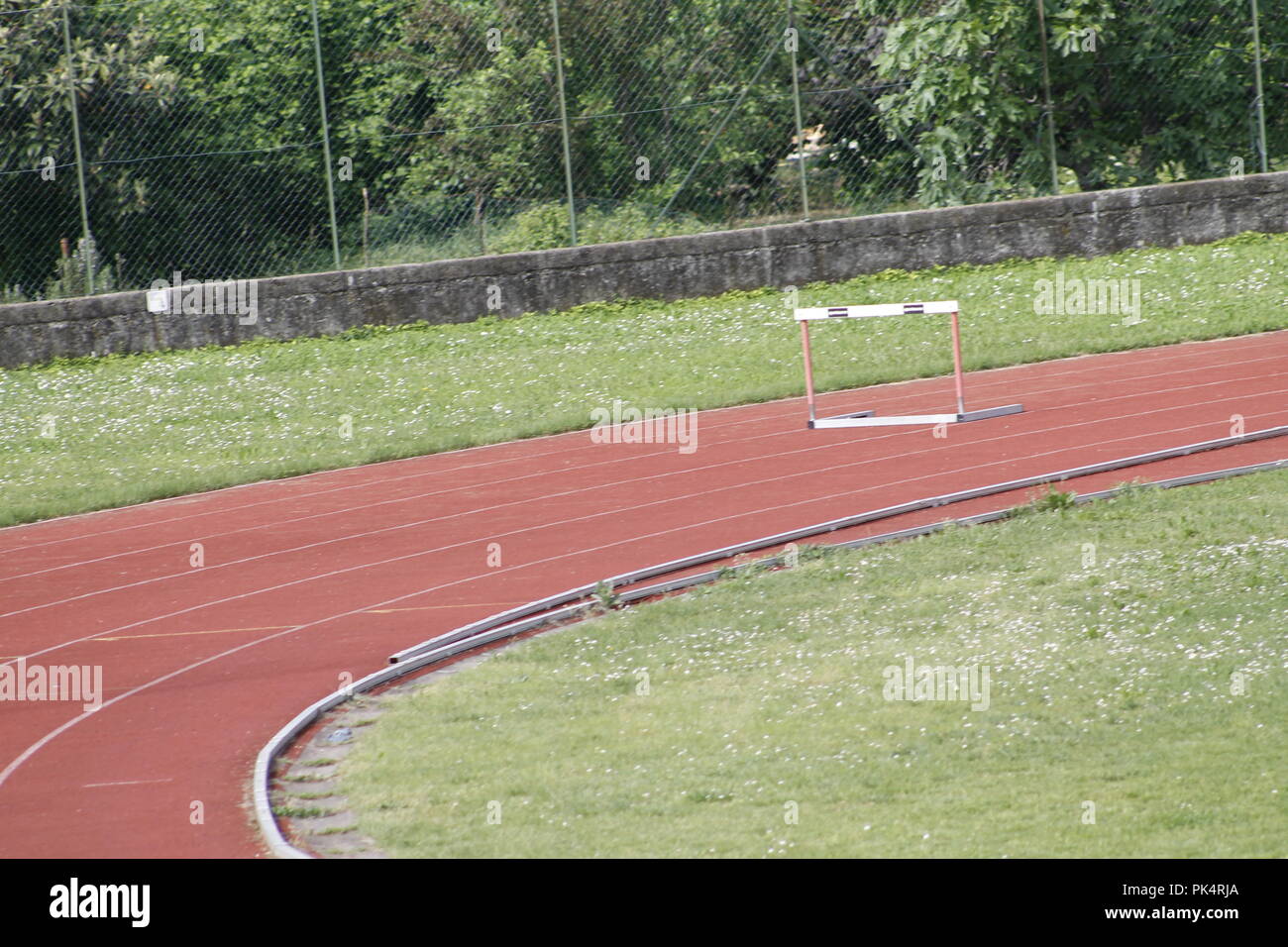 Athlete track or running track among green meadows Stock Photo - Alamy
