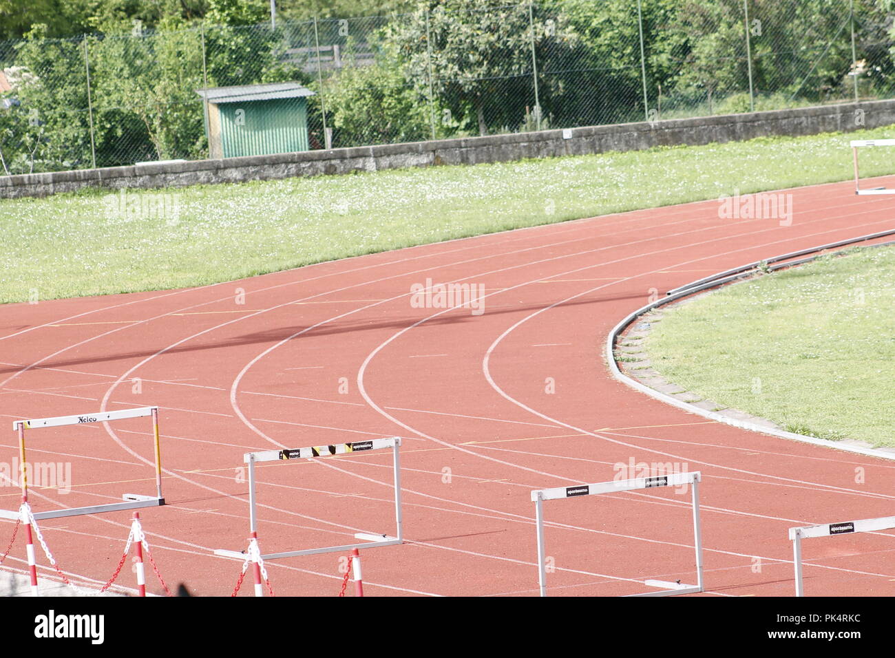 Athlete track or running track among green meadows Stock Photo - Alamy