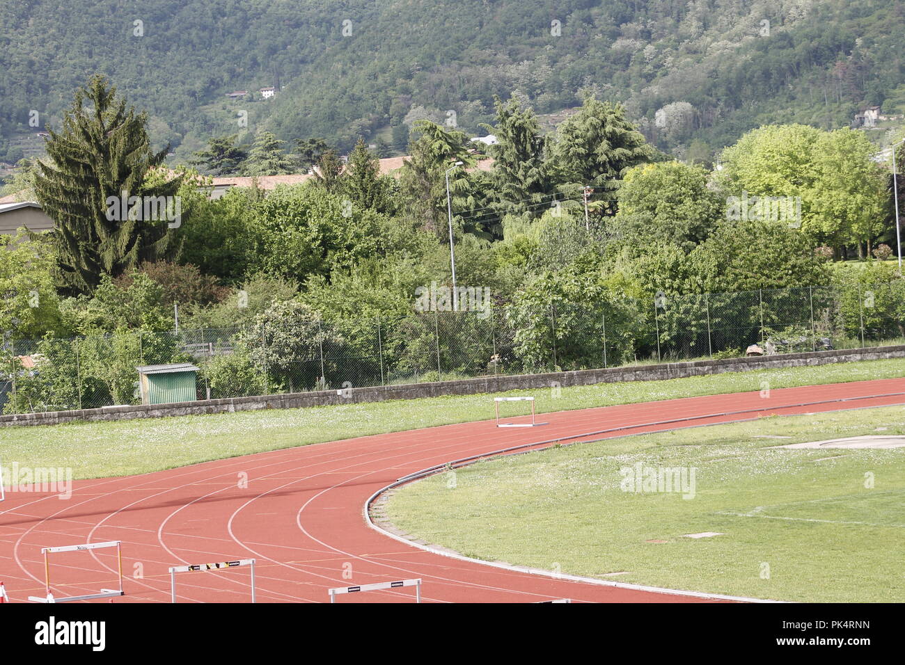 Athlete track or running track among green meadows Stock Photo - Alamy