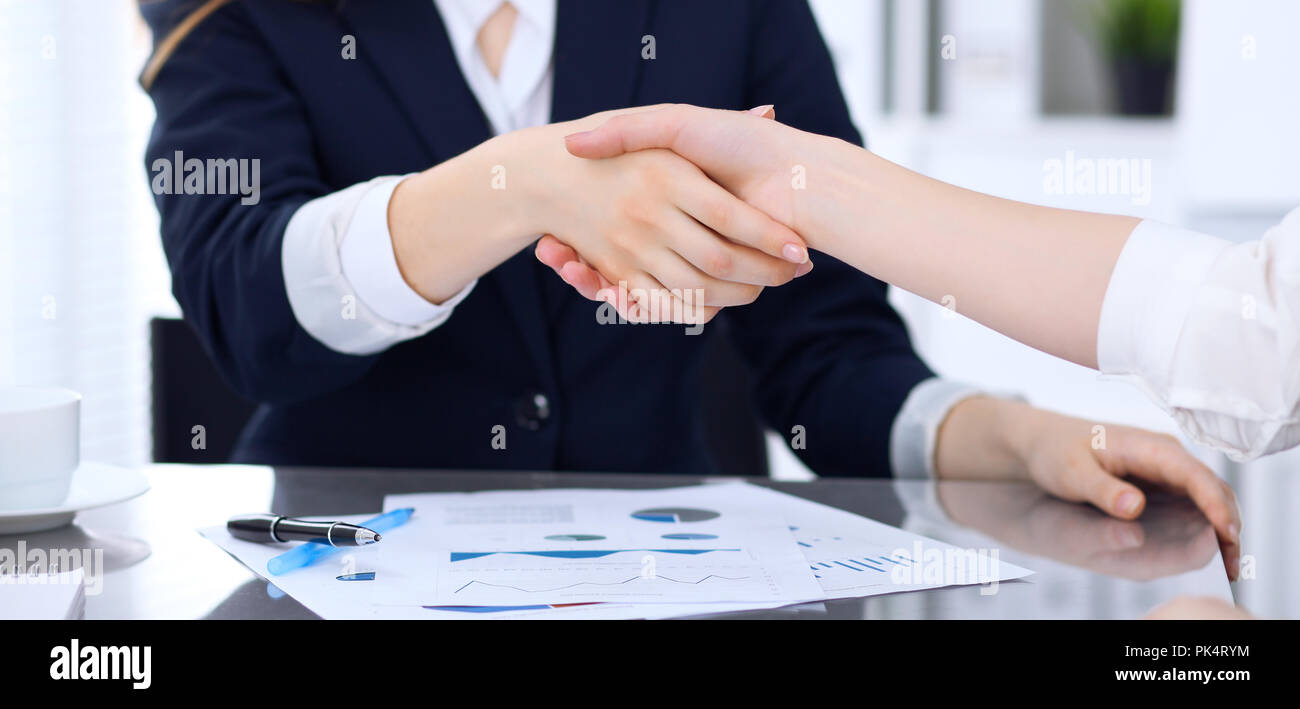 Group of business people shaking hands while finishing up a meeting ...