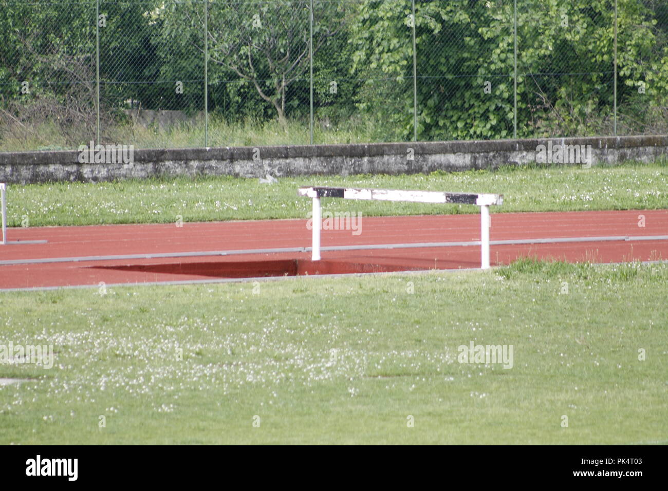 Athlete track or running track among green meadows Stock Photo - Alamy