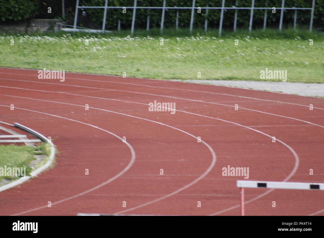 Athlete track or running track among green meadows Stock Photo - Alamy