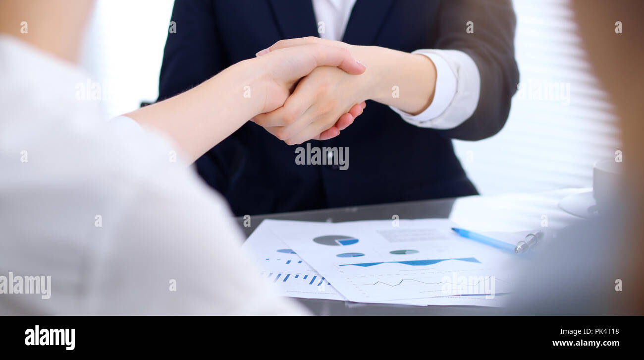Group of business people shaking hands while finishing up a meeting ...