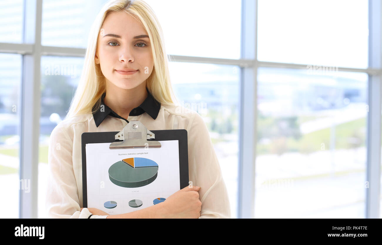 Happy modern business woman or student girl in office hall Stock Photo ...