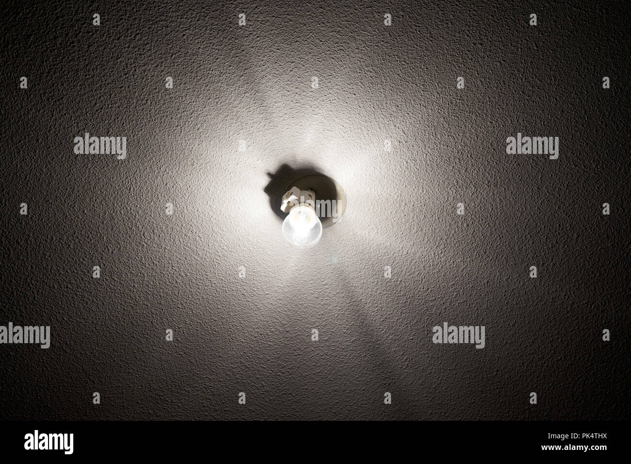 Light Bulb On White Ceiling Stock Photo - Alamy