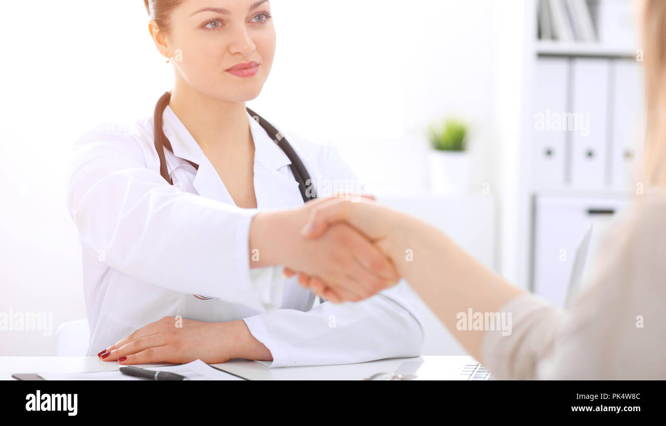 Doctor and patient shaking hands to each other. Healthcare, medicine ...