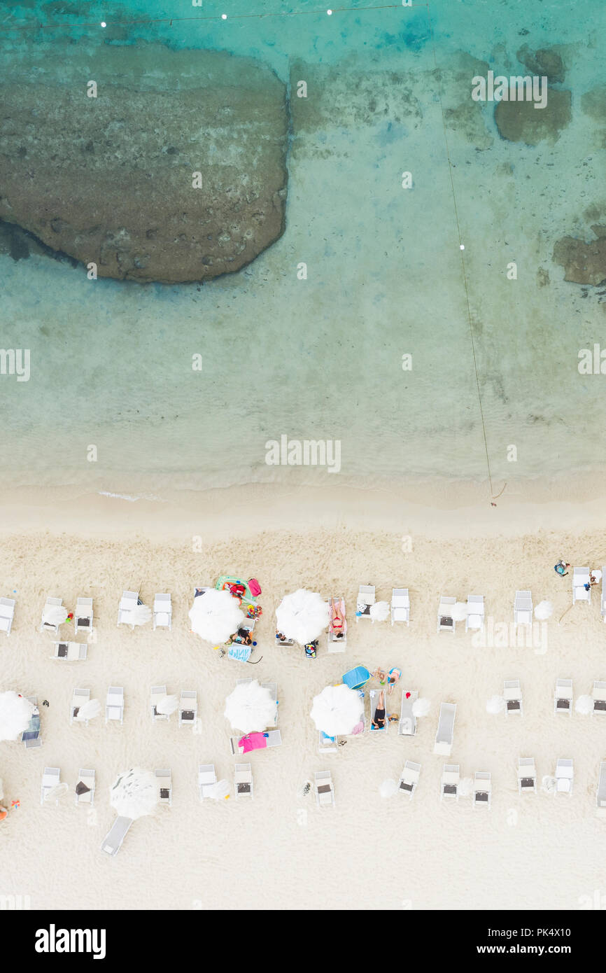 Aerial view of an amazing white beach with white beach umbrellas and ...