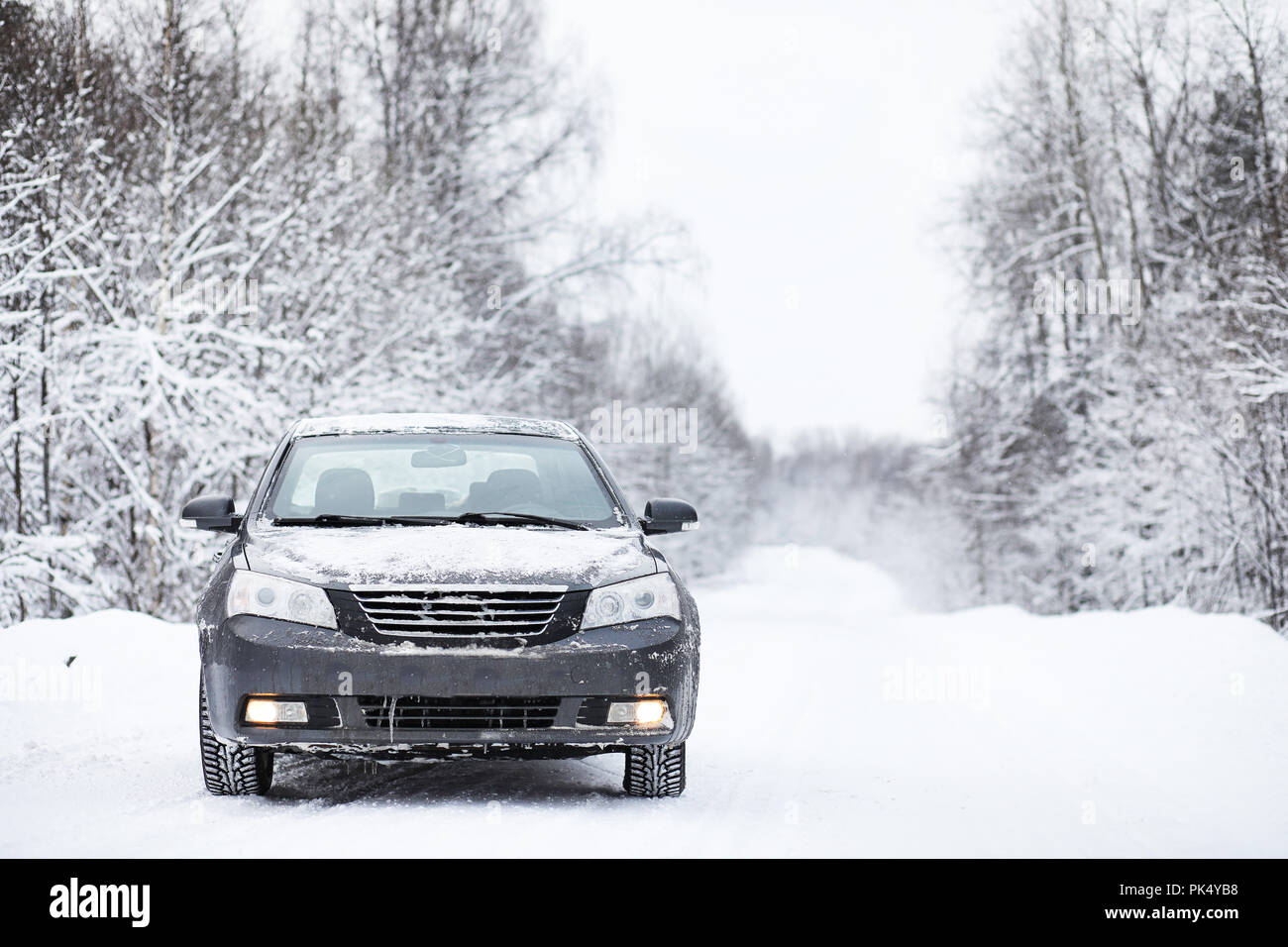 The car stands on a snow-covered road Stock Photo - Alamy