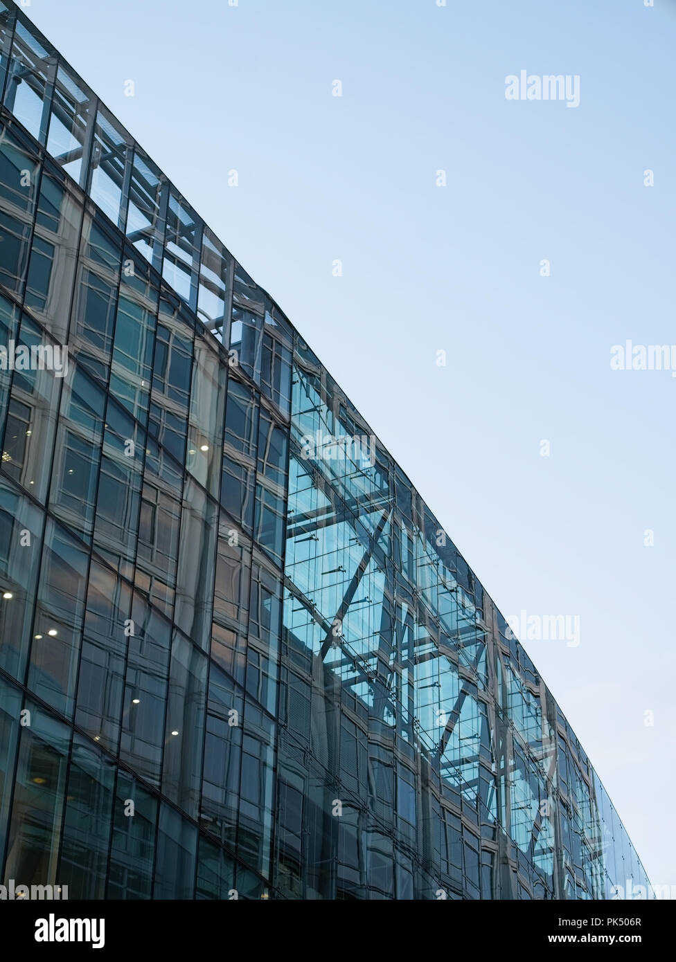 Close-up of modern corporate building with large glass windows against ...