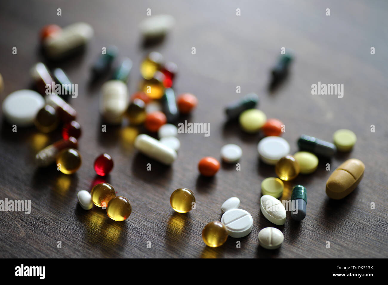 Medications and tablets on a wooden texture table Stock Photo - Alamy