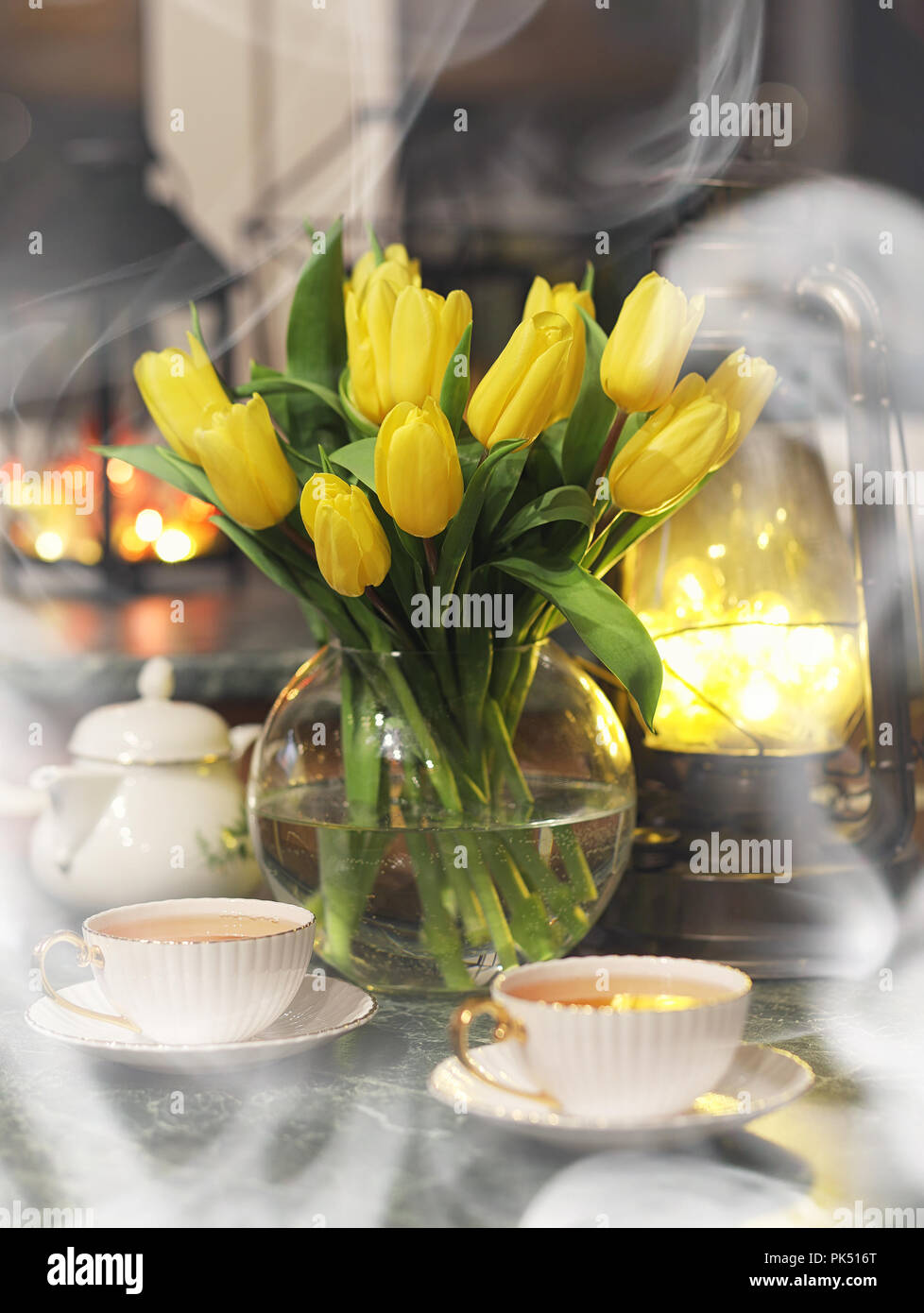 A bouquet of yellow tulips in a vase in the interior of a retro Stock ...